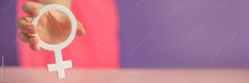 Gender symbol of a woman. Banner with woman symbol in hands on purple ...