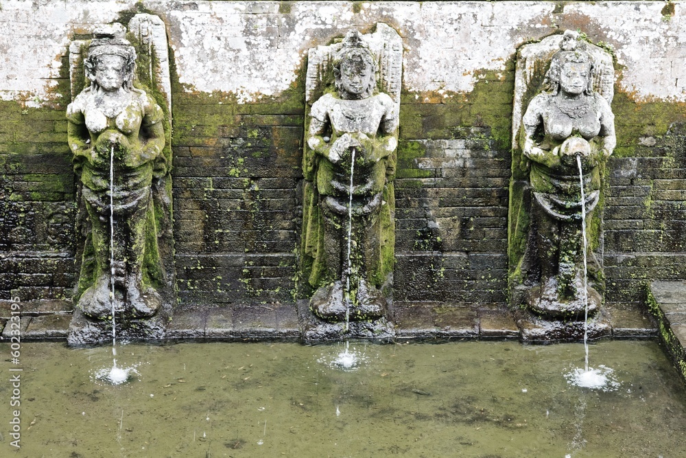 Ancient water dispensing statues at the Goa Gajah temple in Ubud, Bali ...