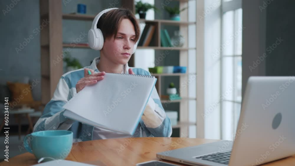 Young Boy Listening Music in Headphones and Writing in Notebook Looking ...