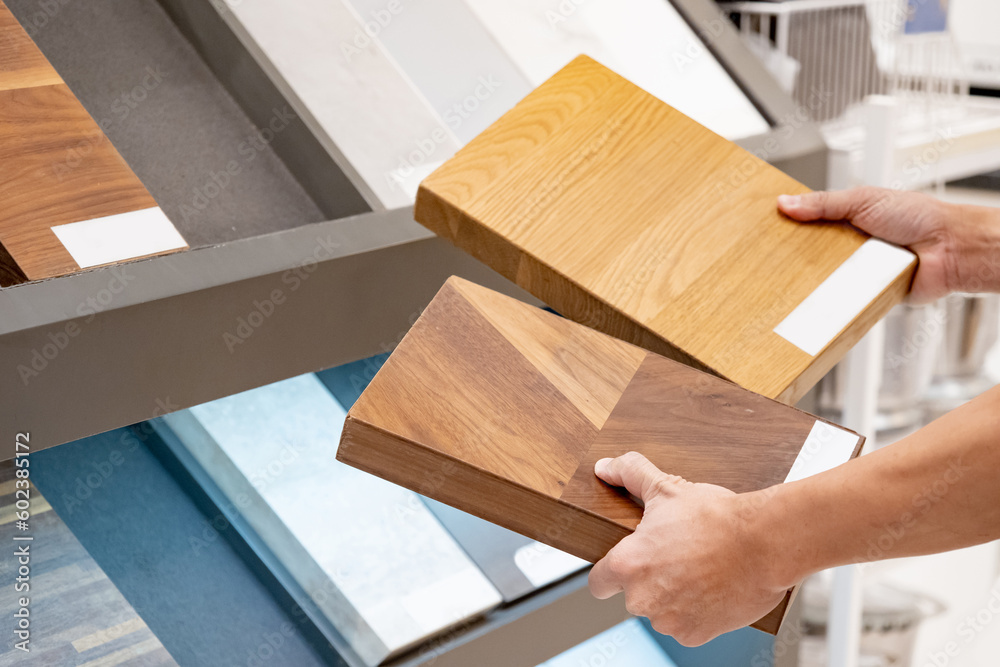 Home interior material design. Male hand choosing sample of wooden ...