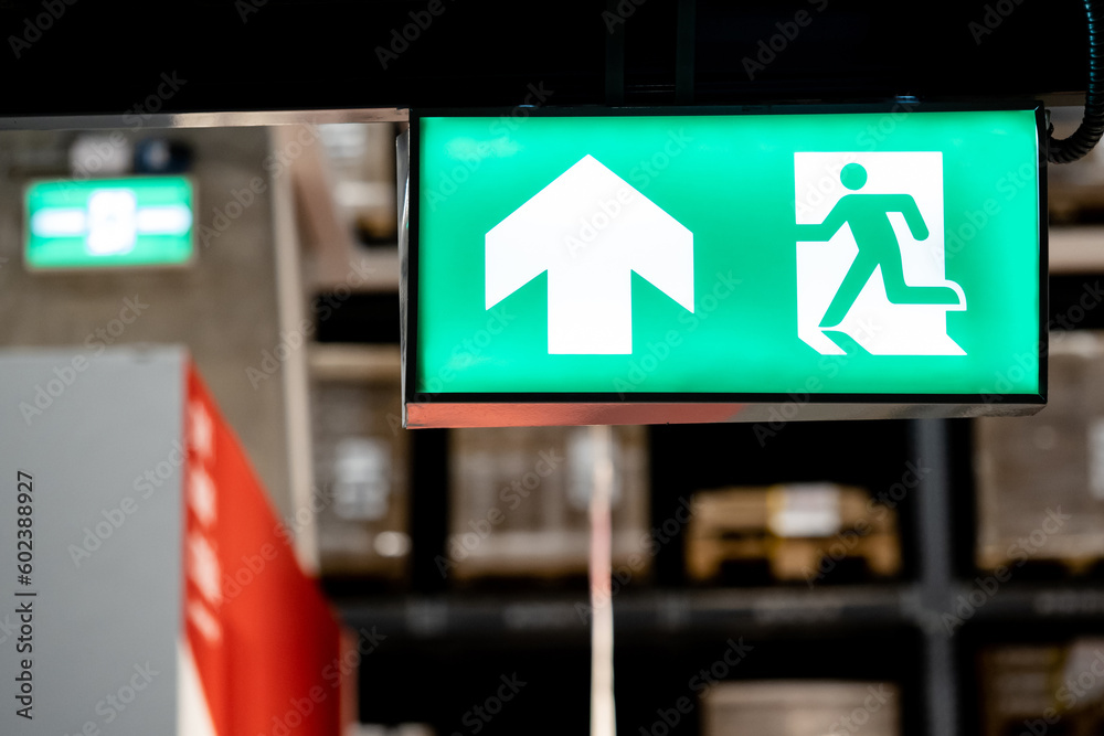 Emergency exit sign or fire exit sign hanging on rack structure in ...