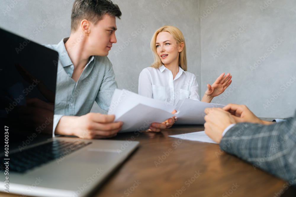 Confused male and female employers covertly discuss unrecognizable job ...