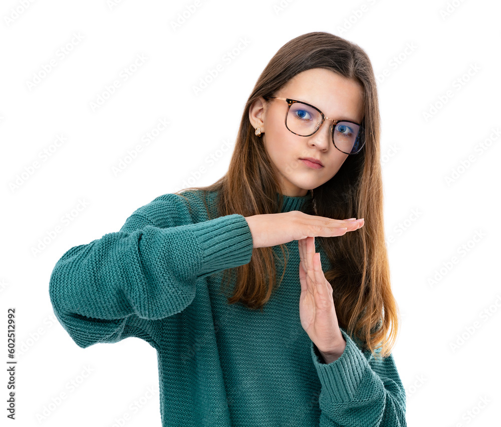 Portrait of twelve year old teenager in glases making a timeout gesture ...