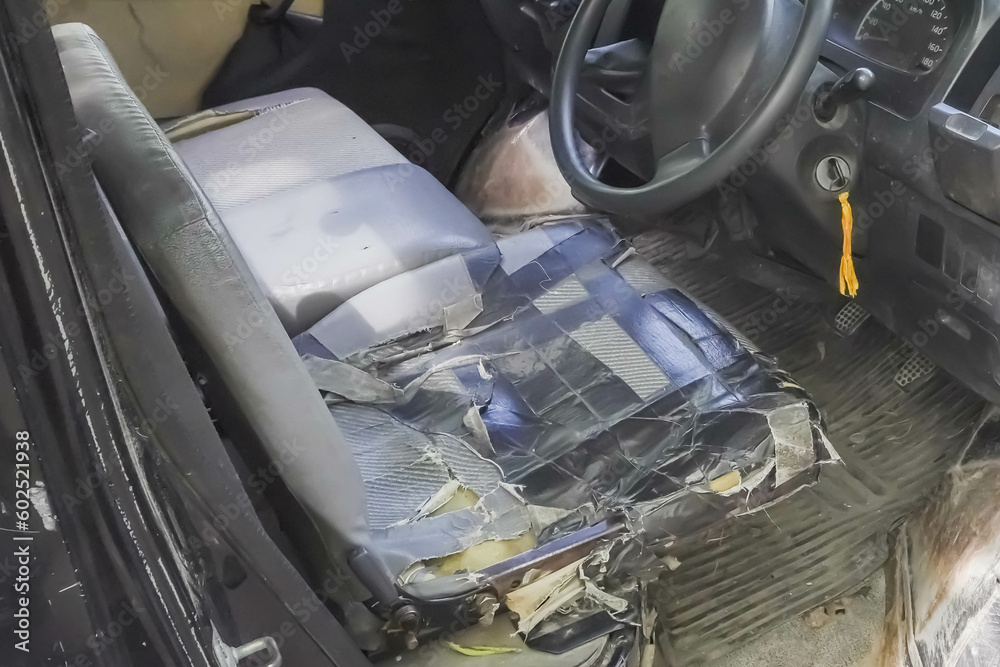 Interior of old car seat is badly damaged and broken full of tape ...