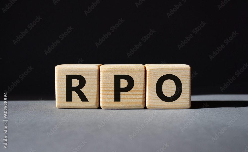 RPO - Recruitment Process Outsourcing symbol. Wooden cubes with words ...
