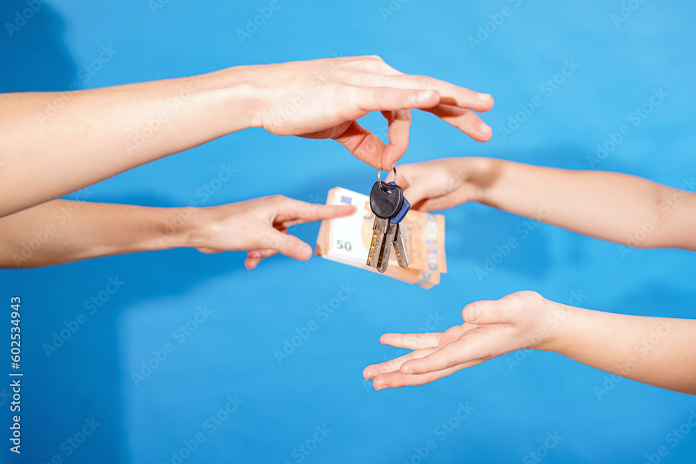 Car keys in exchange for euro banknotes. Purchase and sale of transport ...