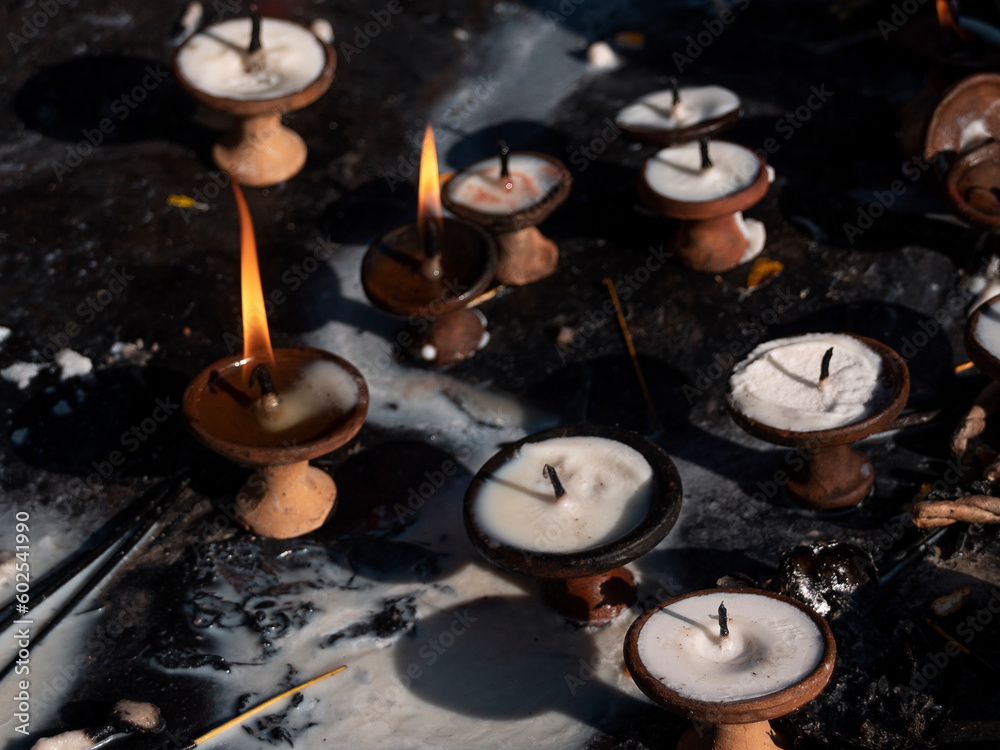 Horizontal view of butter lamps as buddhist offerings in Swambunath ...