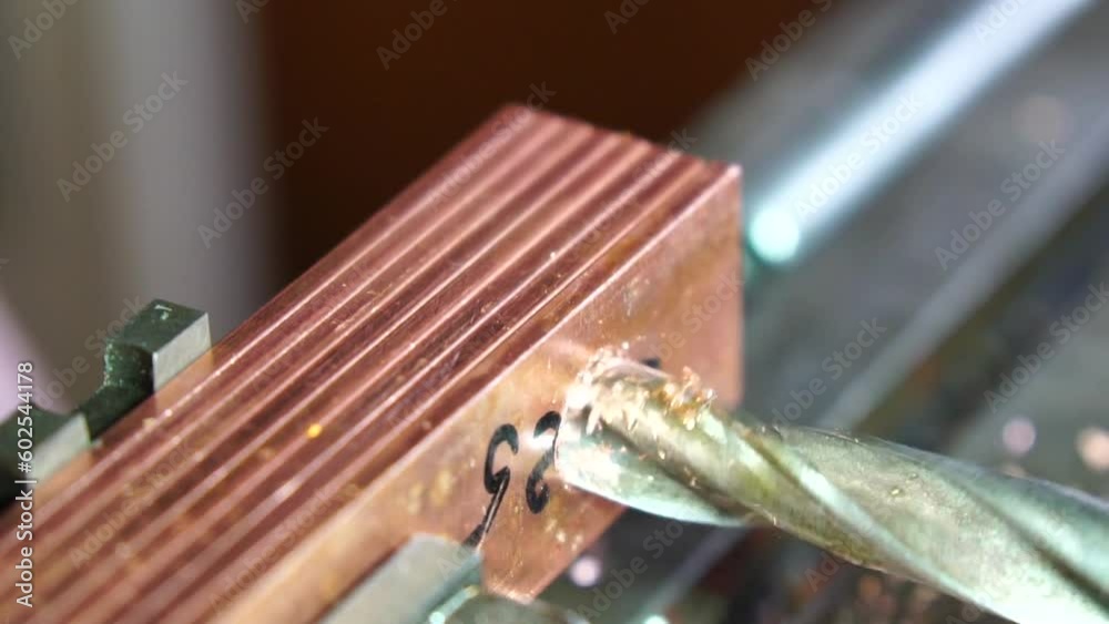 metalworking industry: close up hole drilling in copper bars for ...