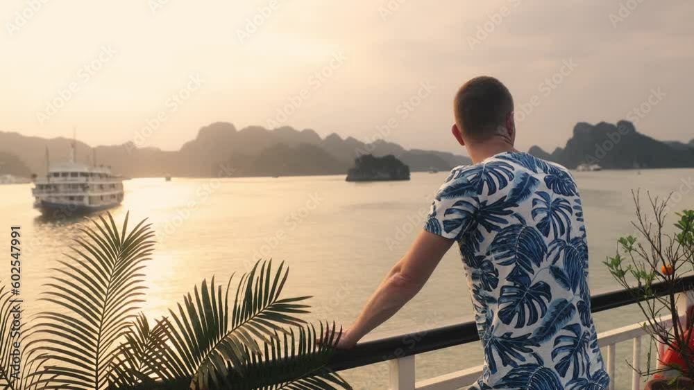 Man enjoying magnificent view from cruise ship sailing between islands ...
