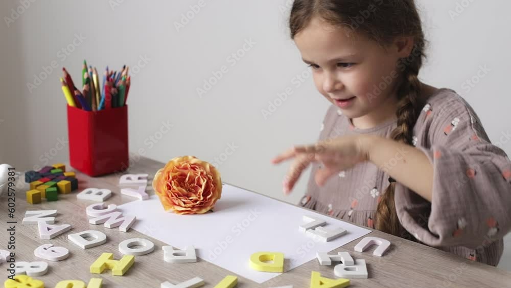 school girl trying to make a word. Kids learn to read. Colorful letters ...