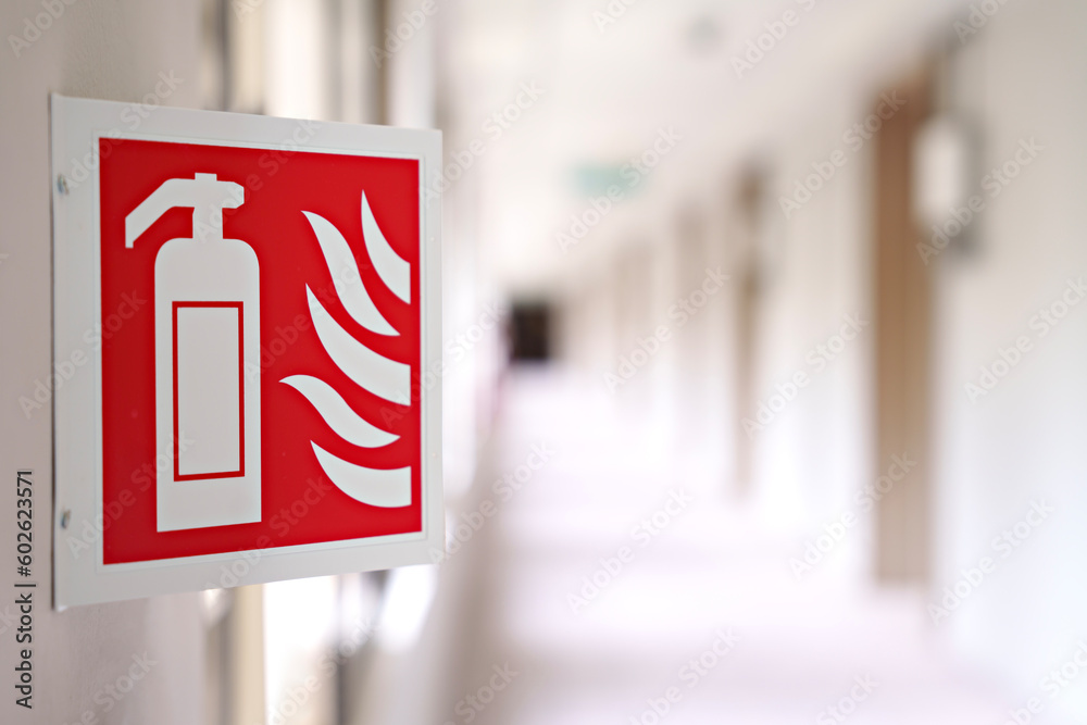 Close-up image features an emergency sign of a fire extinguisher in a ...