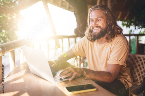 Happy Caucasian man enjoying online networking in social media during ...