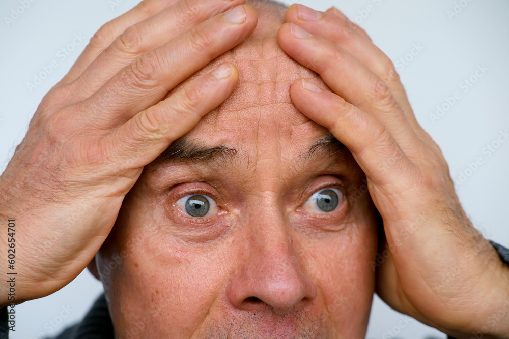 mature man, senior 60 years old crying from physical or moral pain ...