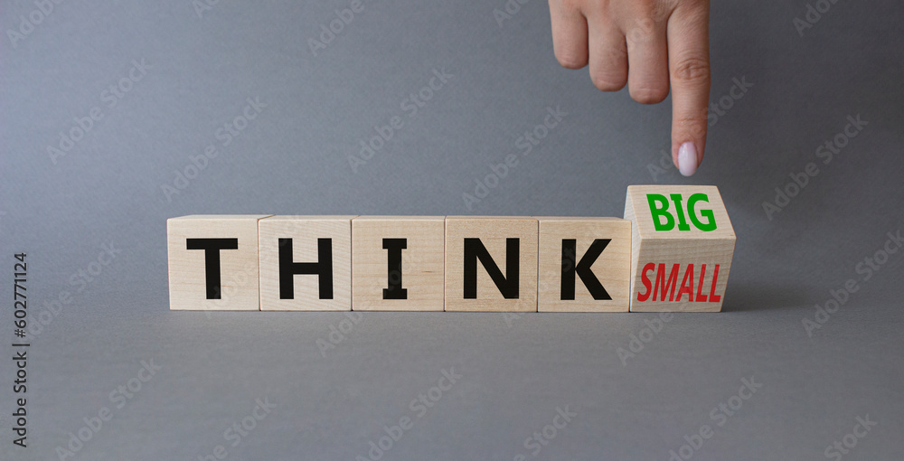 Think Big vs Small symbol. Businessman Hand points at wooden cubes with ...