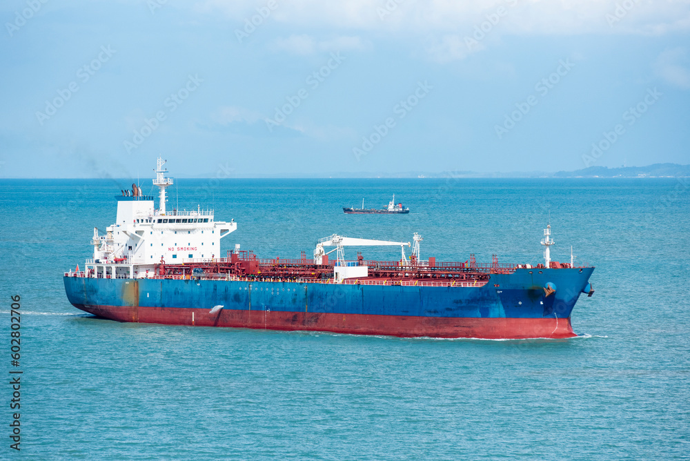 Cargo ship, oil tanker, sailing through peaceful, calm, blue sea on her ...