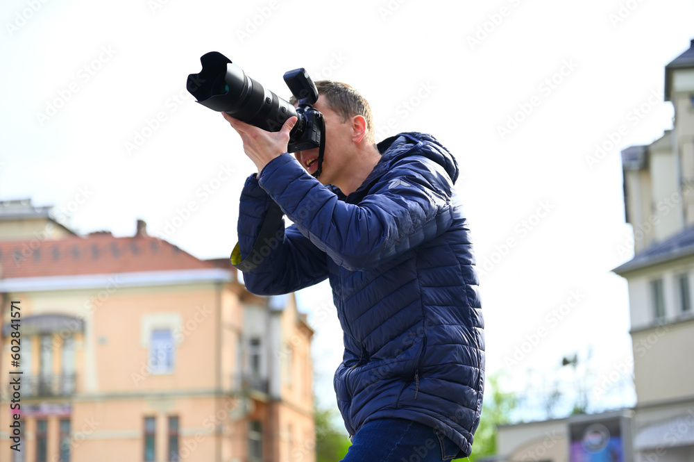The paparazzi is seen taking a photo of a celebrity in an urban setting ...
