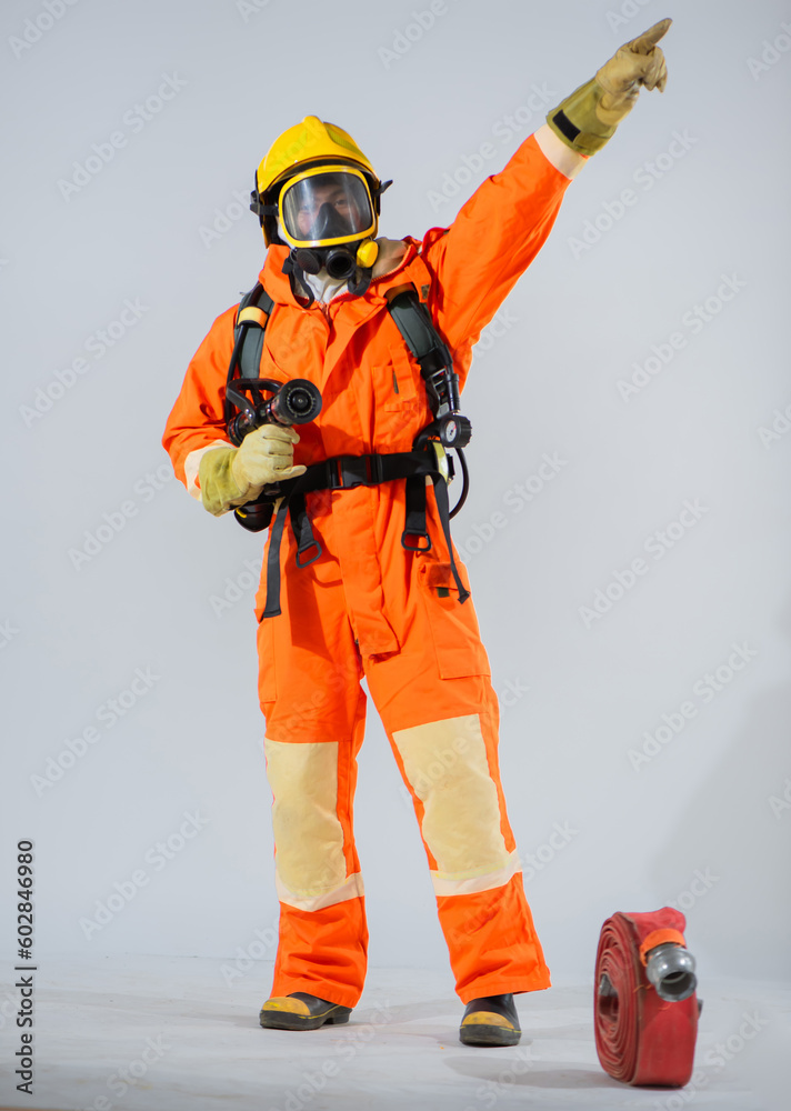 Vertical picture of firefighter standing and pointing finger to the top ...