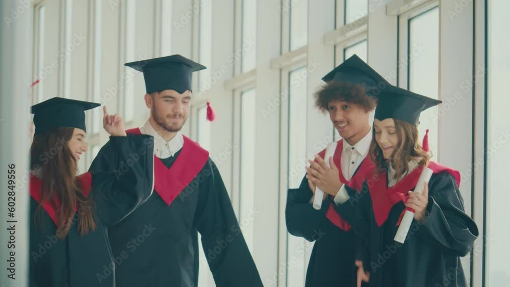 Positive Group of Successful Graduates Dancing With Diplomas in Hallway ...