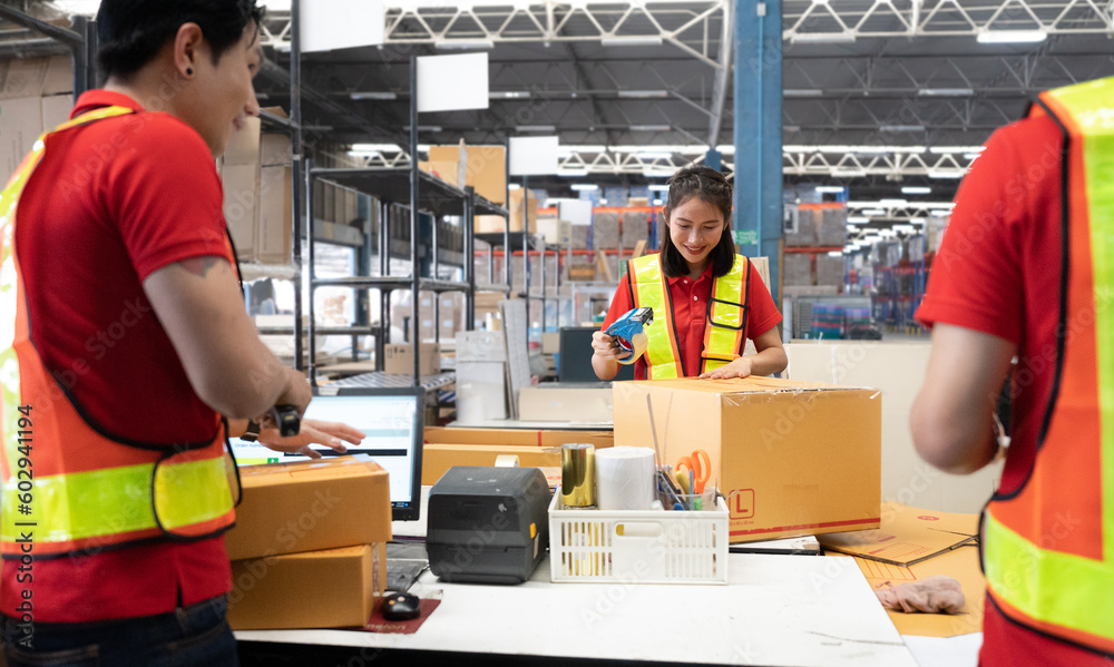 Warehouse staff packing goods for shipping order dispatch. Asian woman ...