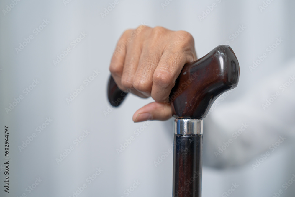 physical therapy elderly woman on a walking wood standard cane in ...