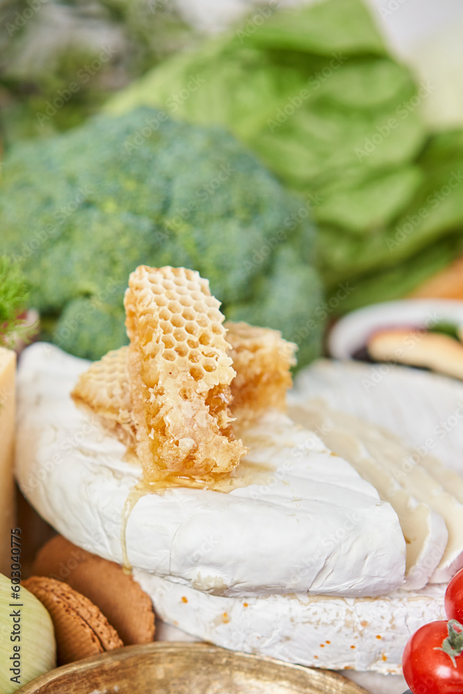 Brie cheese with honey close-up. Table full of mediterranean appetizers ...