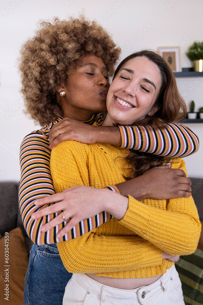 Two Lovely And Happy Homosexual Women Embracing At Home One Of Them