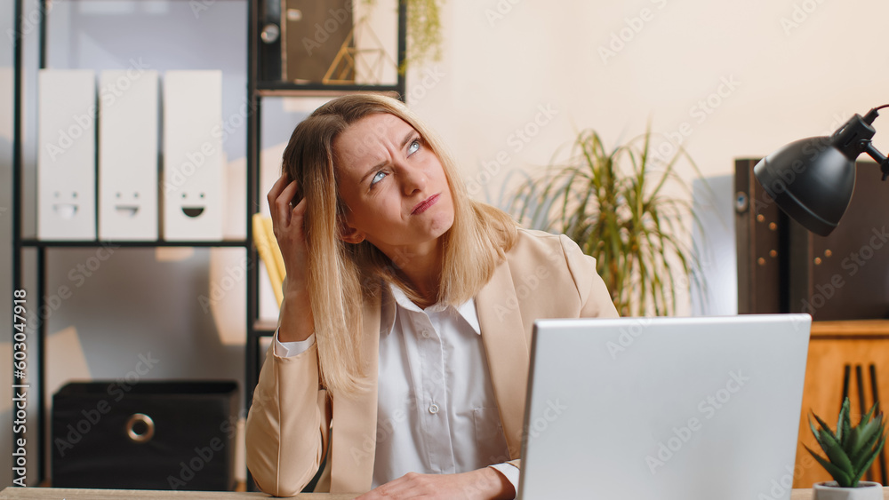 I dont know what to say. Confused business woman working on laptop at ...