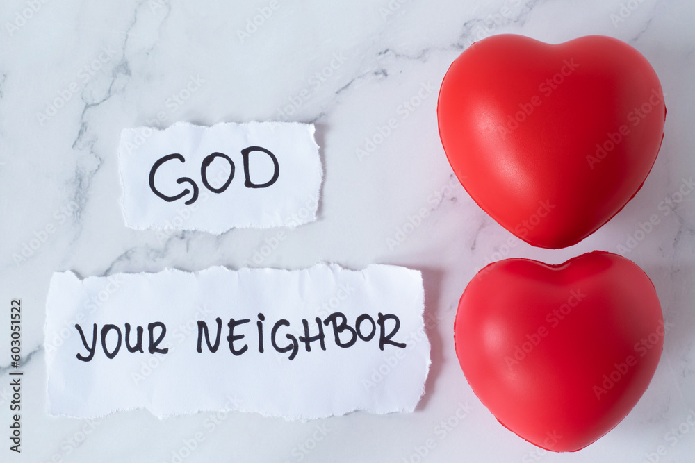 Love God and your neighbor, handwriting on paper with two red hearts on ...