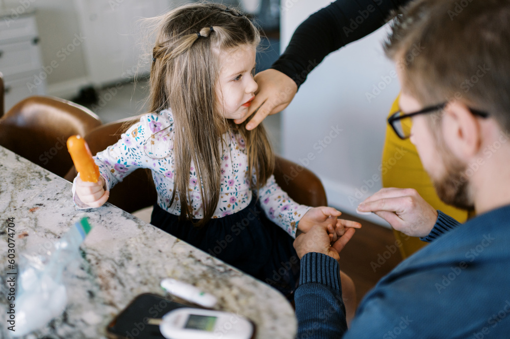 sad crying toddler getting blood sugar measured and eating popsicle ...