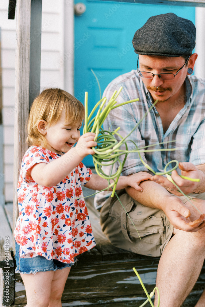 Foto de father sitting on porch with his daughter, doing farm chores ...
