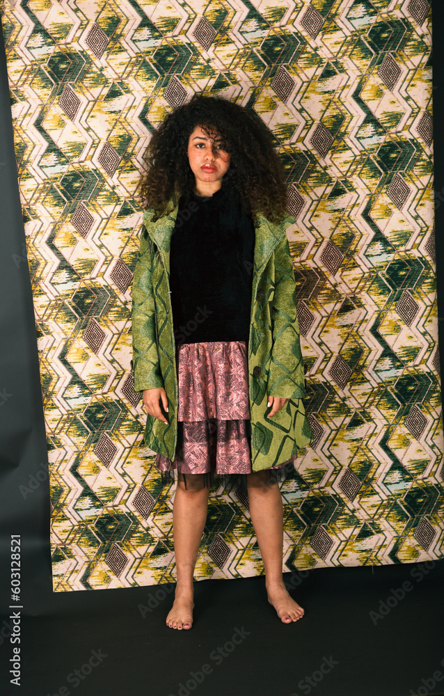 Young Girl With Curly Hair Standing In Front Of Colorful Background 0586