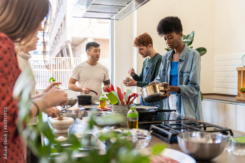 Multiracial Group Of Friends Cooking A Meal Together. Stock Photo ...
