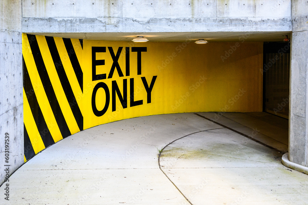 Exit only sign on entire wall of underground garage exit Stock Photo ...