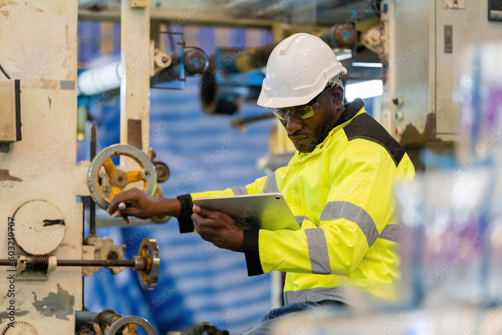 african engineer Controlling work via tablet Wear uniforms and helmets ...