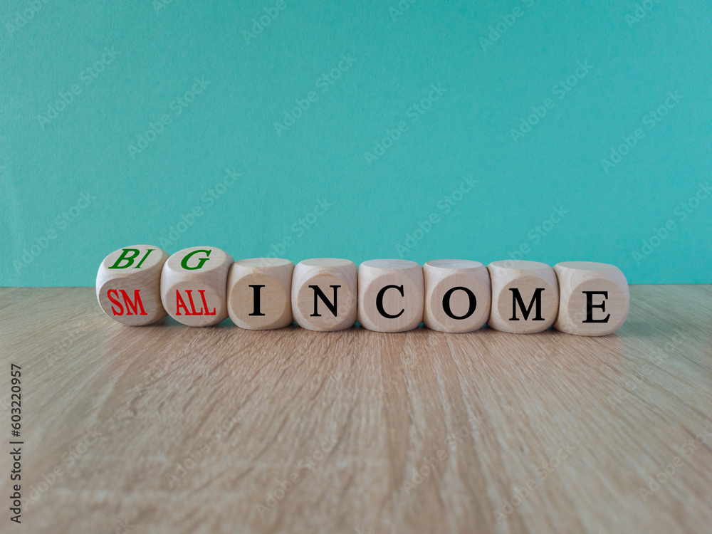 Big or small income symbol.Turned wooden cubes and changes words Small ...