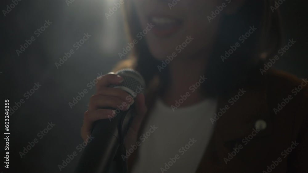 Close-up microphone Attractive singer woman singing music on stage with ...