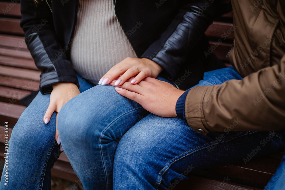 Close up black woman and man in love sitting on couch two people holding hands. Symbol sign ...