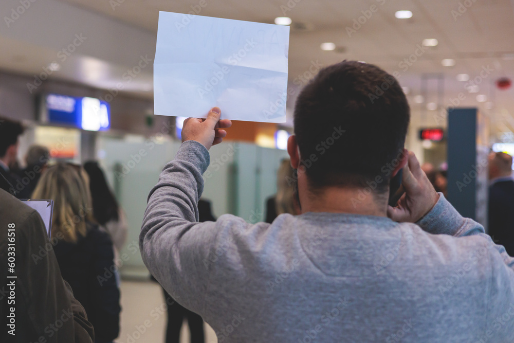 Meeting at the airport, person holding a placard card sign with welcome ...