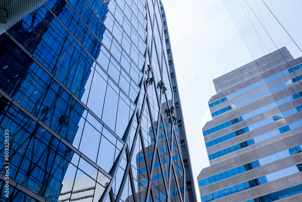 Workers washing windows of the skyscraper building. Window washer ...