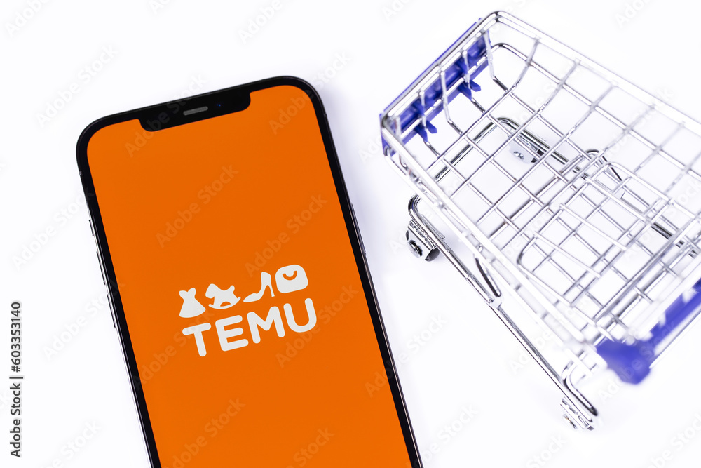 Temu mobile logo app on a smartphone iPhone screen and trolley ...