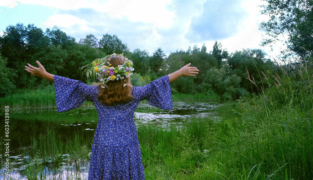 girl in flower wreath outdoor, abstract natural background. rear view ...