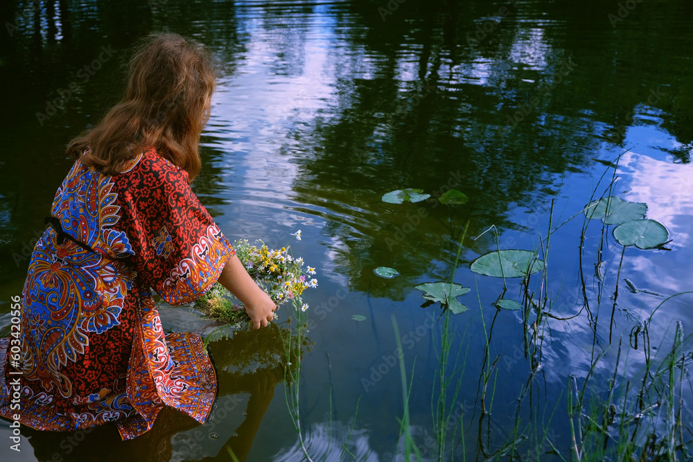girl near river and holding flower wreath, abstract natural background ...