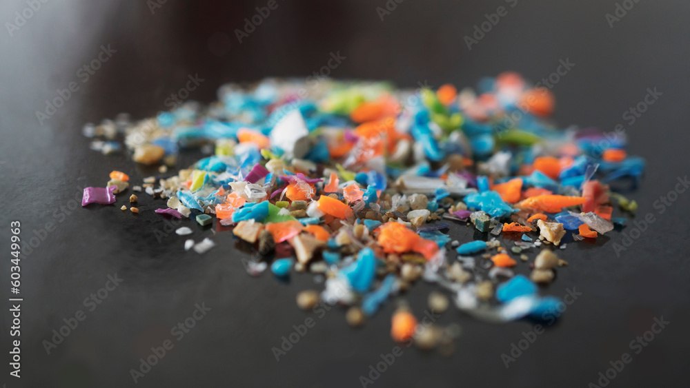 Macro shot on a pile of micro plastic particles and sand. Concept for ...