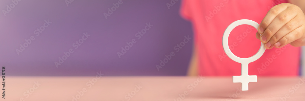 Gender symbol of a woman. Banner with woman symbol in hands on purple ...