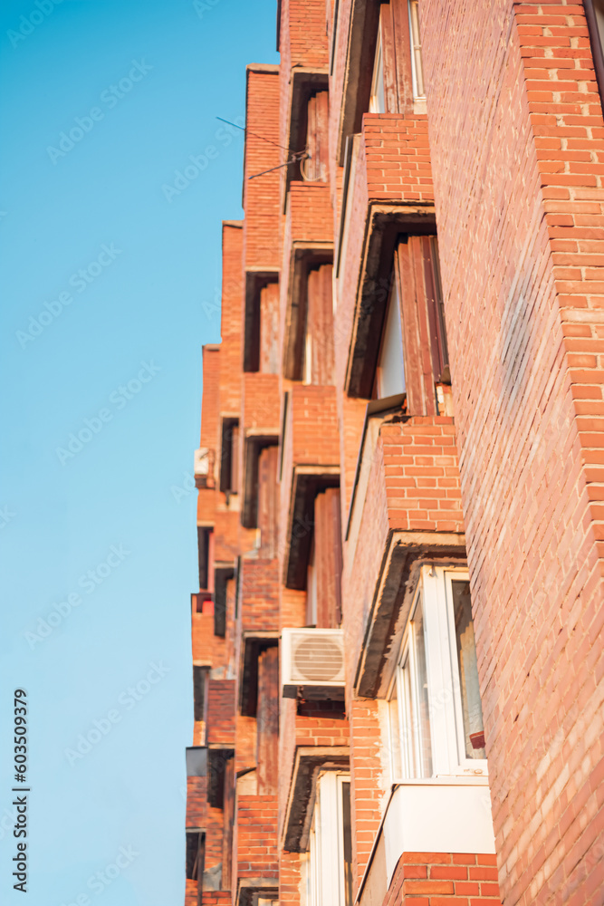 red brick building. red wall with balcony and windows. architecture of ...