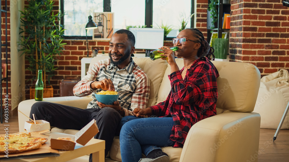 African american couple having fun watching television, ordering ...