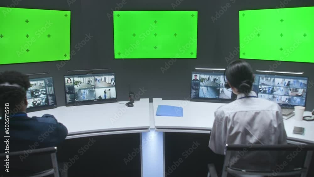 Mixed race male and female officers control CCTV cameras with AI facial ...