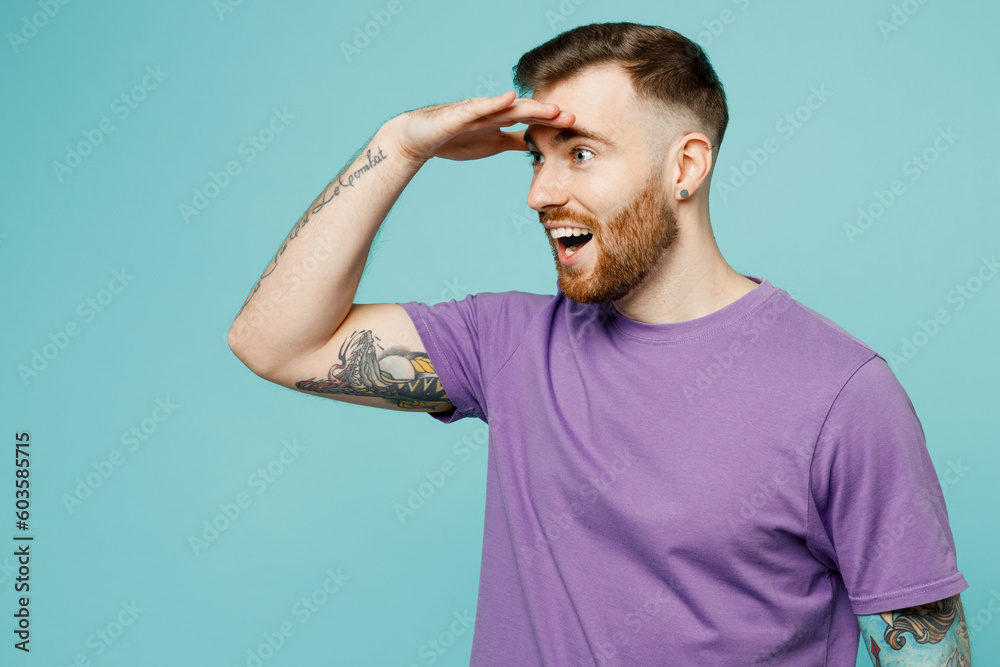 Side view young smiling happy man wear purple t-shirt hold hand at ...