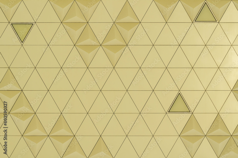 Golden diamond-shaped polished metal cladding panels of a modern ...
