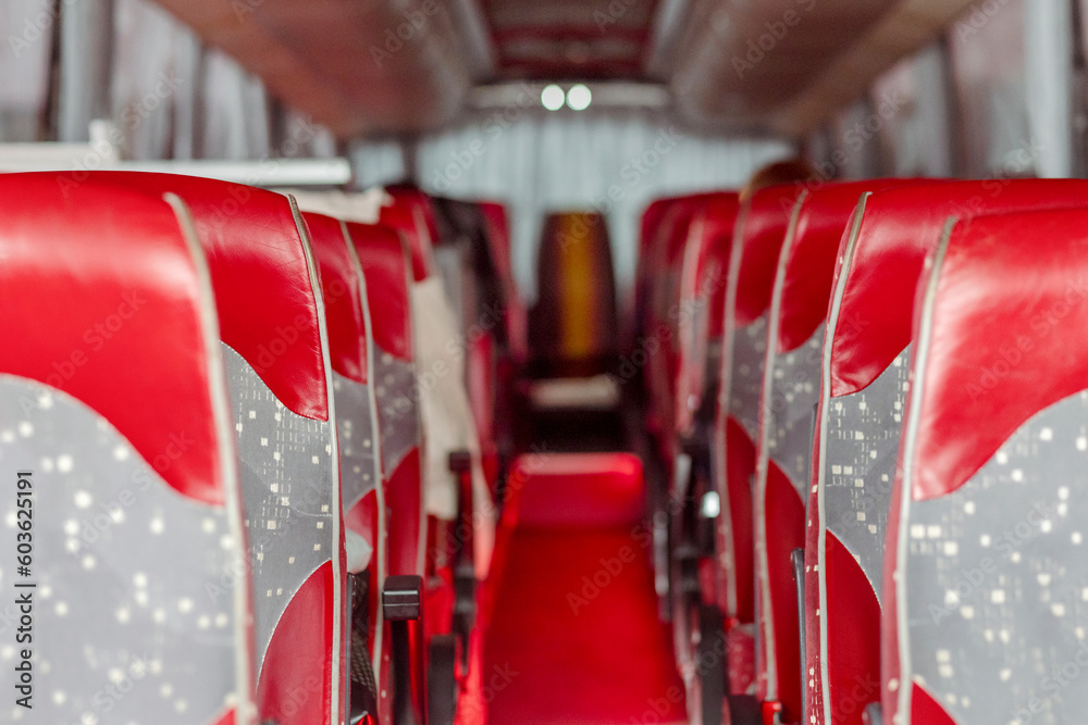Bus inside. Empty interior of Travel Bus. Rows of Red Passenger seats ...